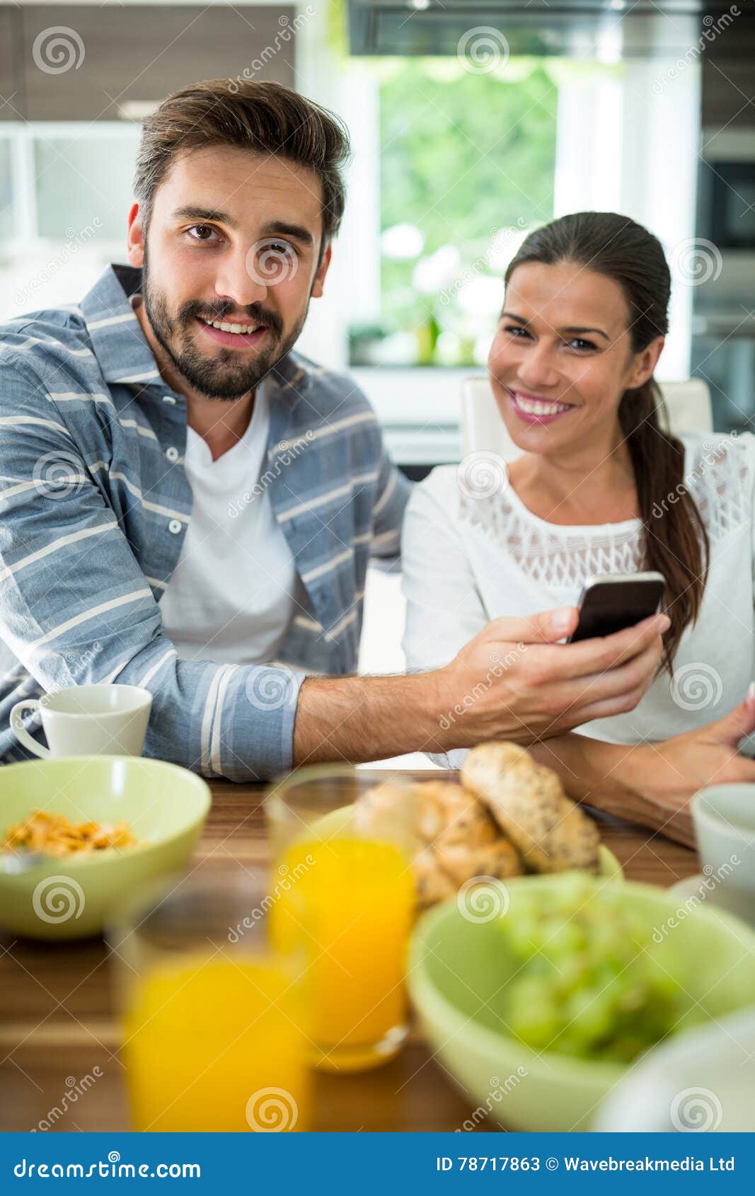 Couple Using Mobile Phone while Having Breakfast at Home Stock Image ...