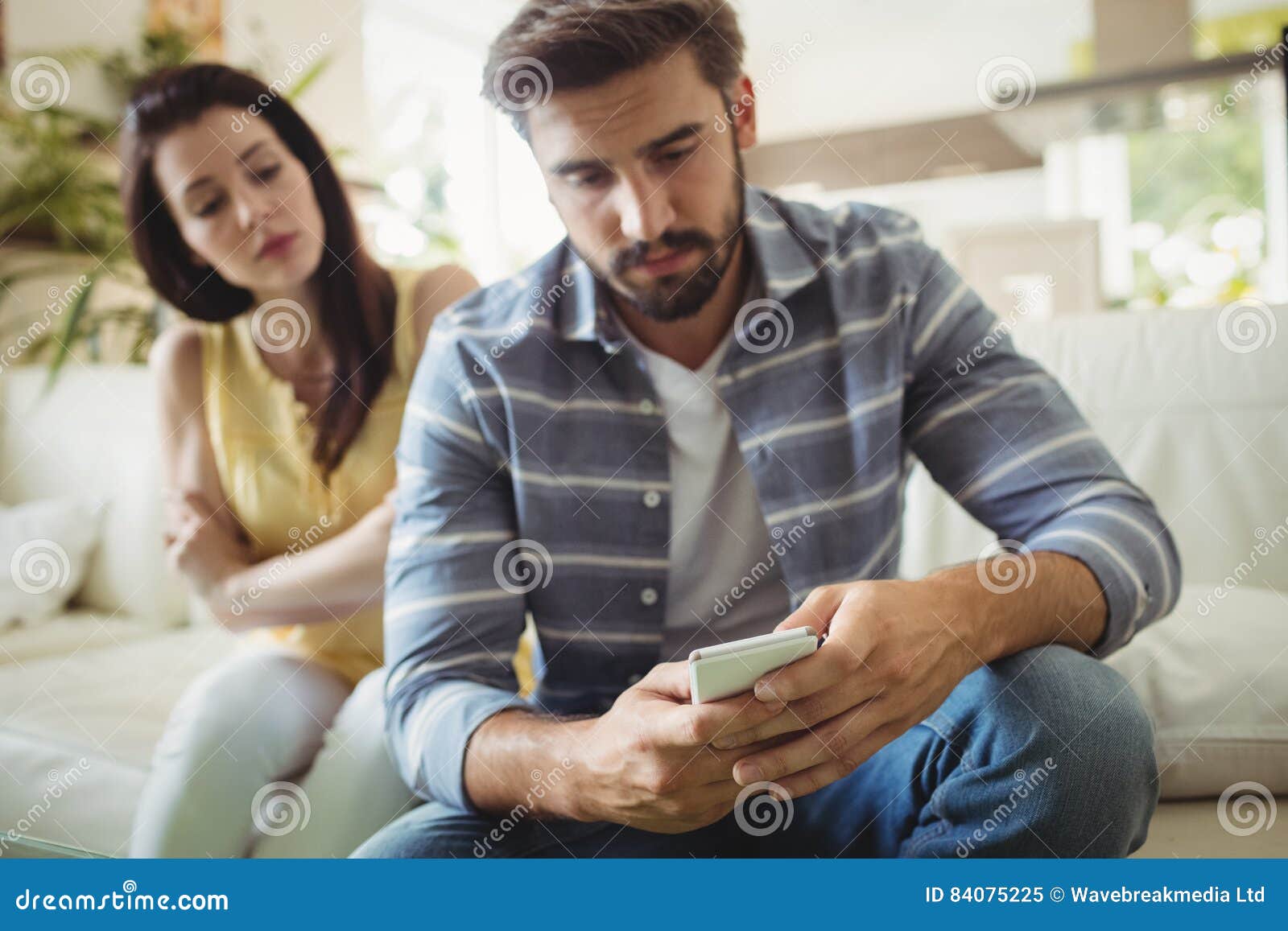Couple Using Mobile Phone on Sofa Stock Image - Image of fondness ...