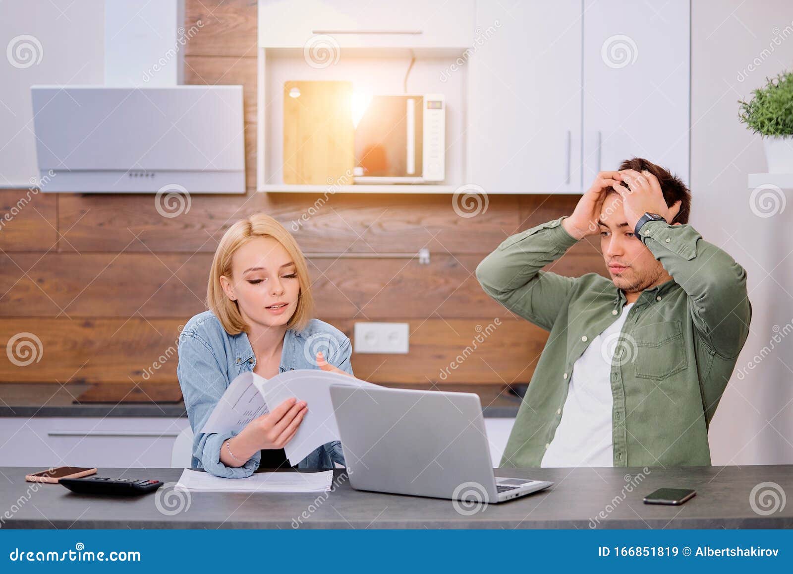 Worried Young Couple Using Laptop Solving Financial Problems at Home ...
