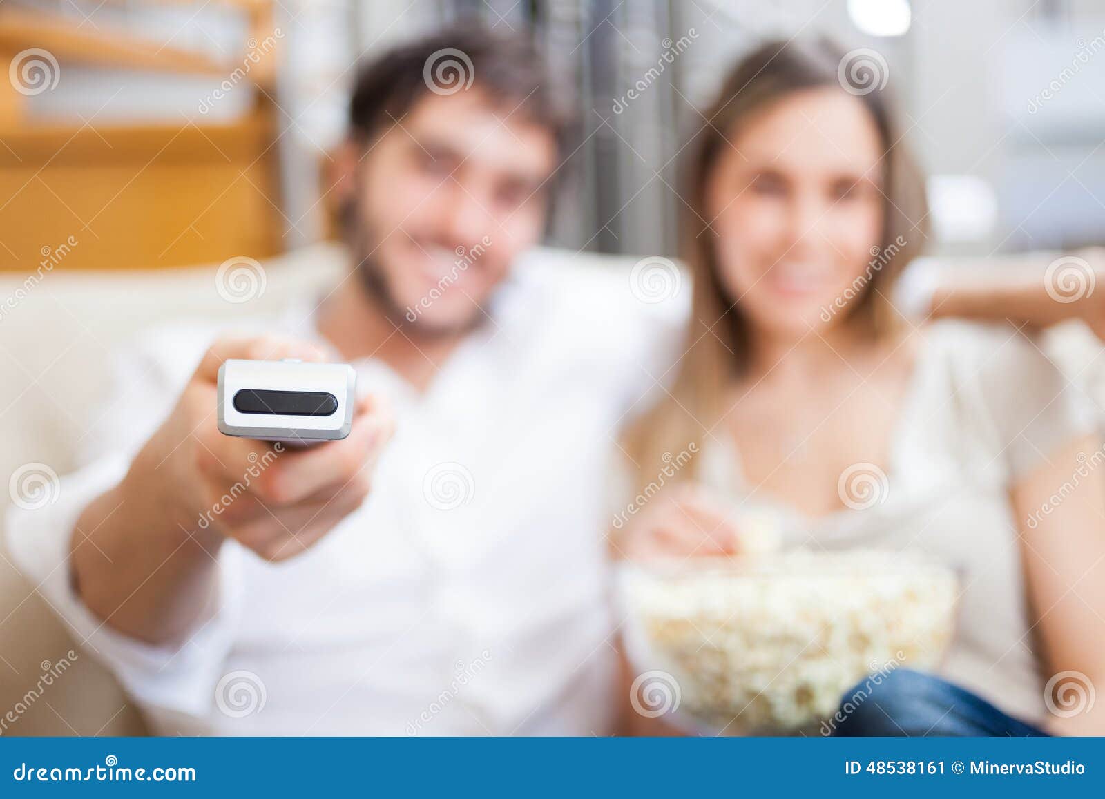 Couple Using a Remote Control Stock Image - Image of home, demand: 48538161
