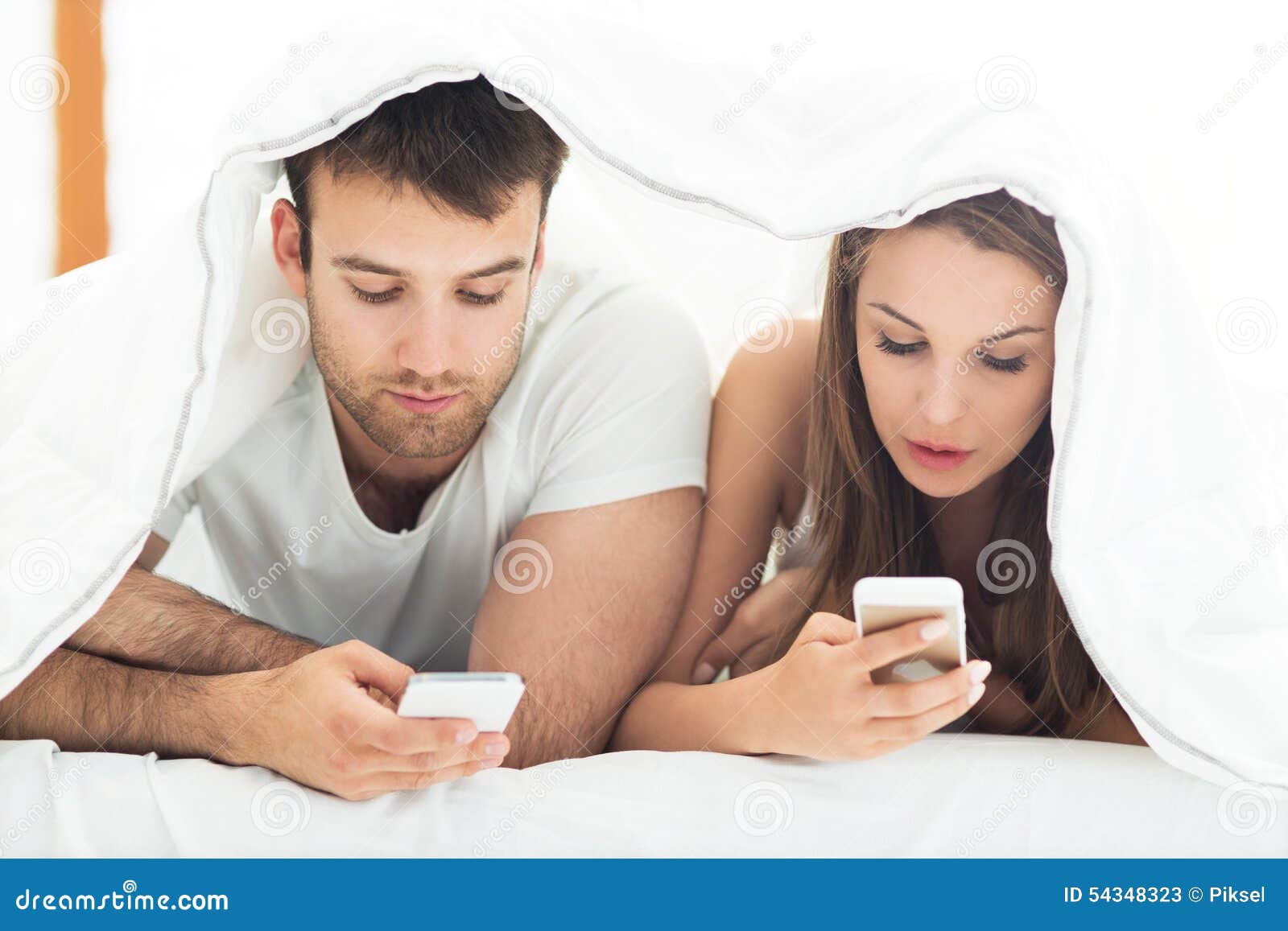 Couple Using Smartphones in Bed Stock Image - Image of enjoying, cozy ...