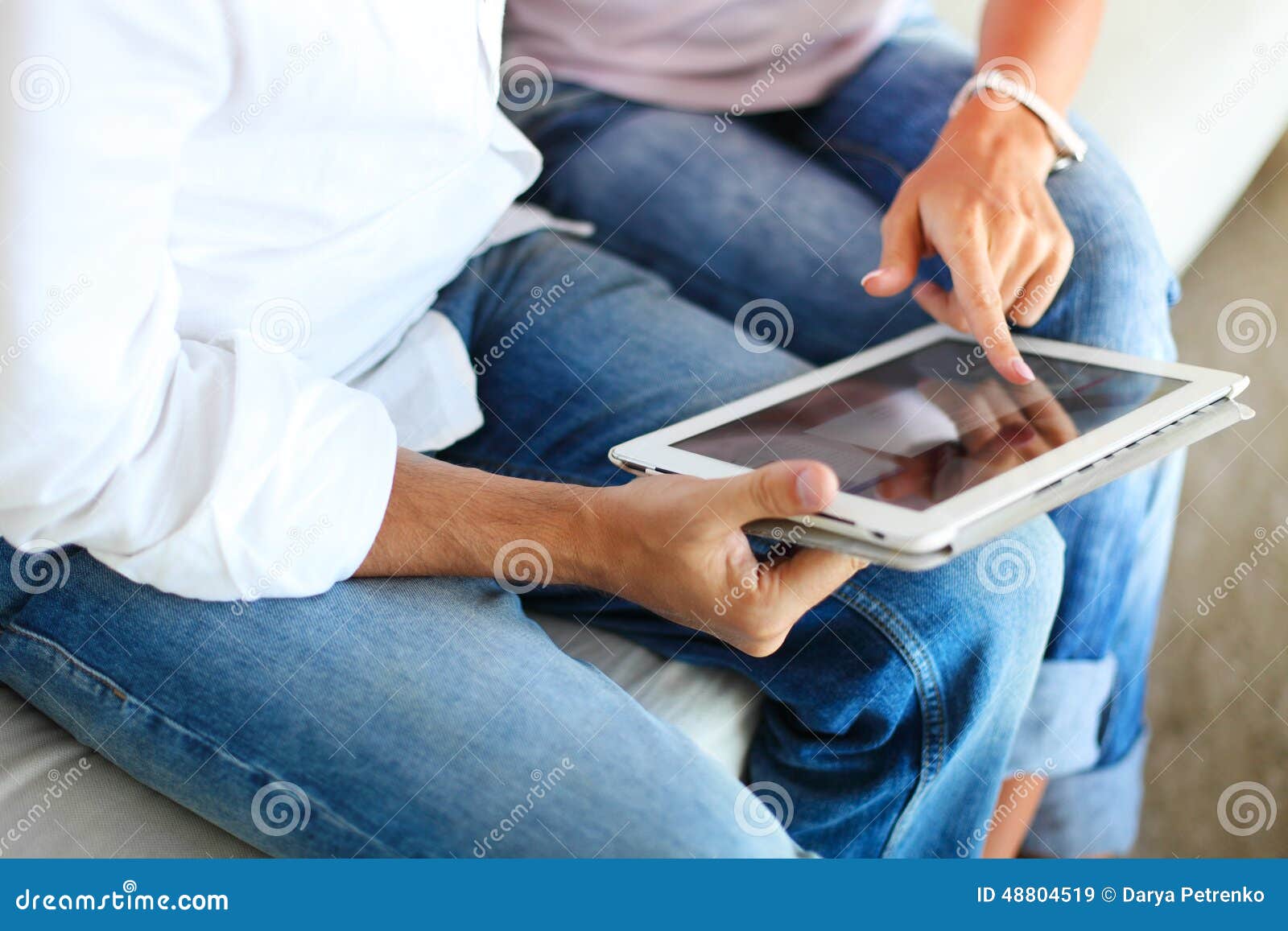 Couple Using a Tablet Computer in Their Living Room Stock Image - Image ...