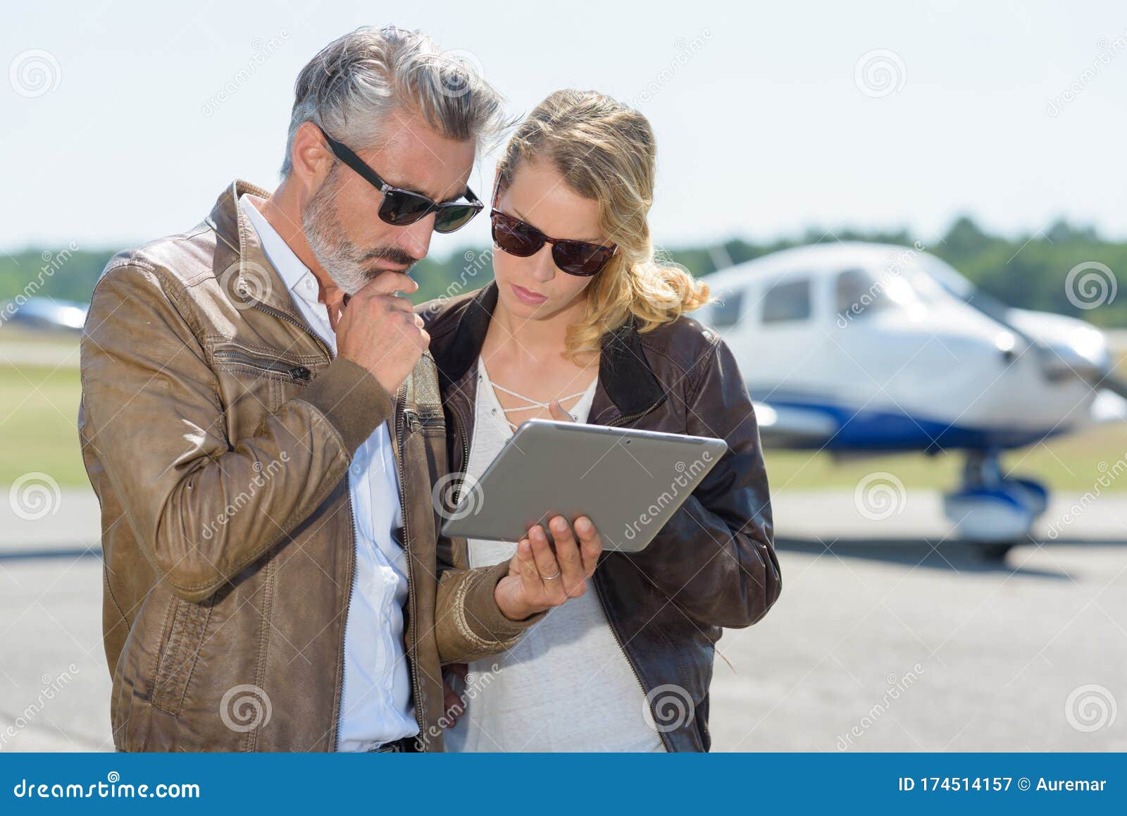 Couple Using Tablet Next To Private Jet Stock Image - Image of smile ...