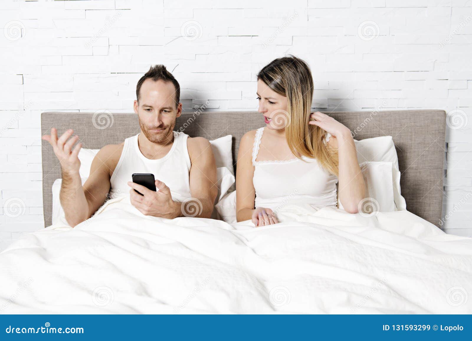 Couple Using Their Mobile Phone in Bed Stock Image - Image of cellphone ...
