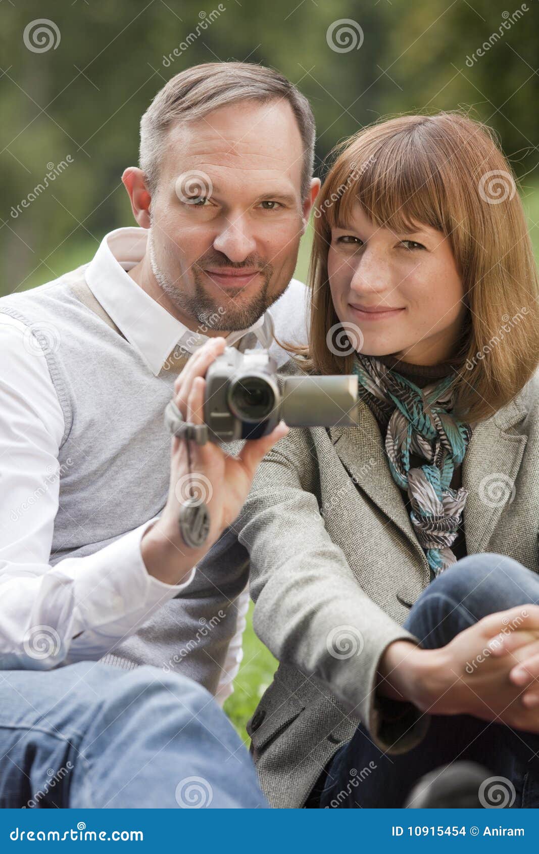 Couple with video camera stock photo. Image of friends - 10915454