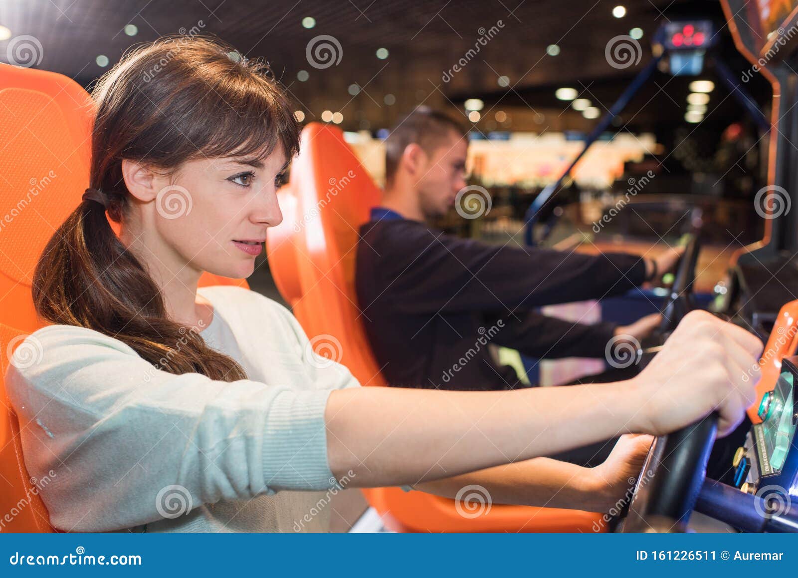 Couple in Video Game Arcade Playing Driving Games Stock Image - Image ...