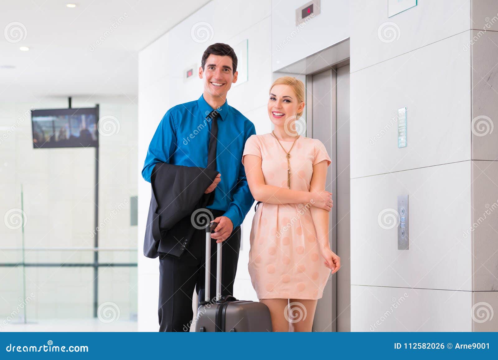 Couple Waiting for Hotel Elevator or Lift Stock Photo - Image of ...