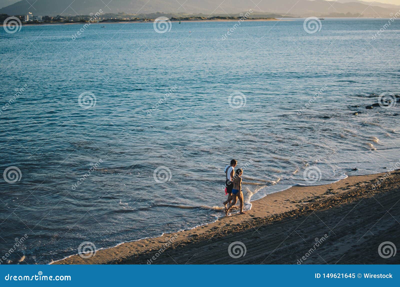 Couple Walking Alongside the Beach Editorial Image - Image of female ...