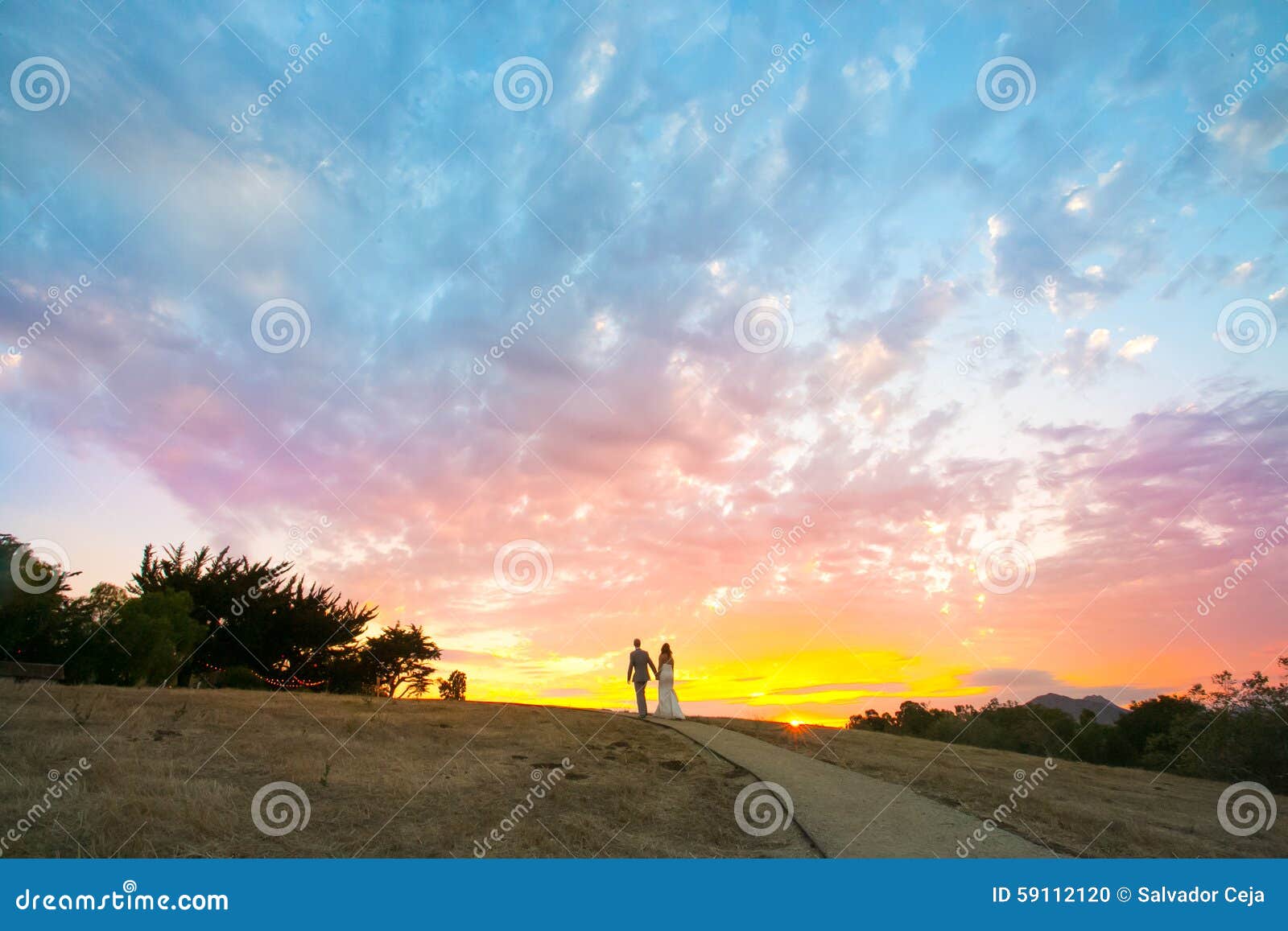 Couple Walking into a Colorful Sunset Stock Photo - Image of ...