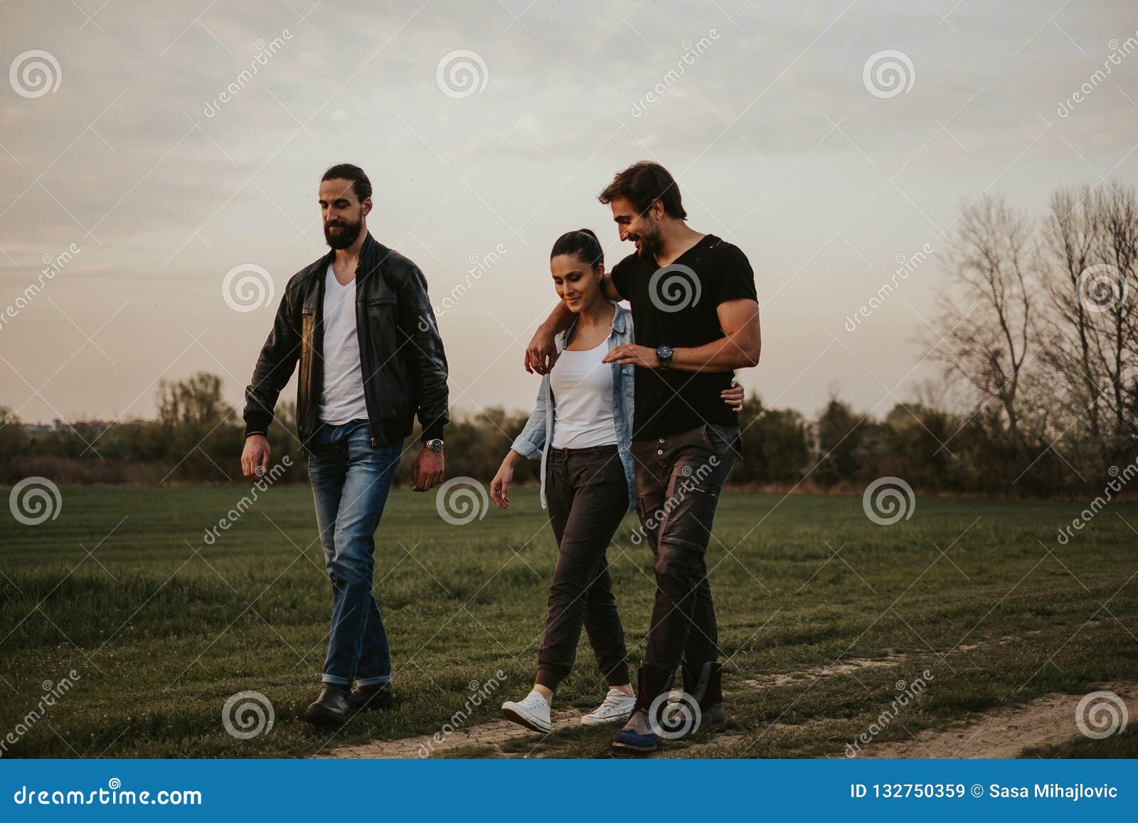 Couple Walking with Friend in Nature and Talking Stock Image - Image of ...