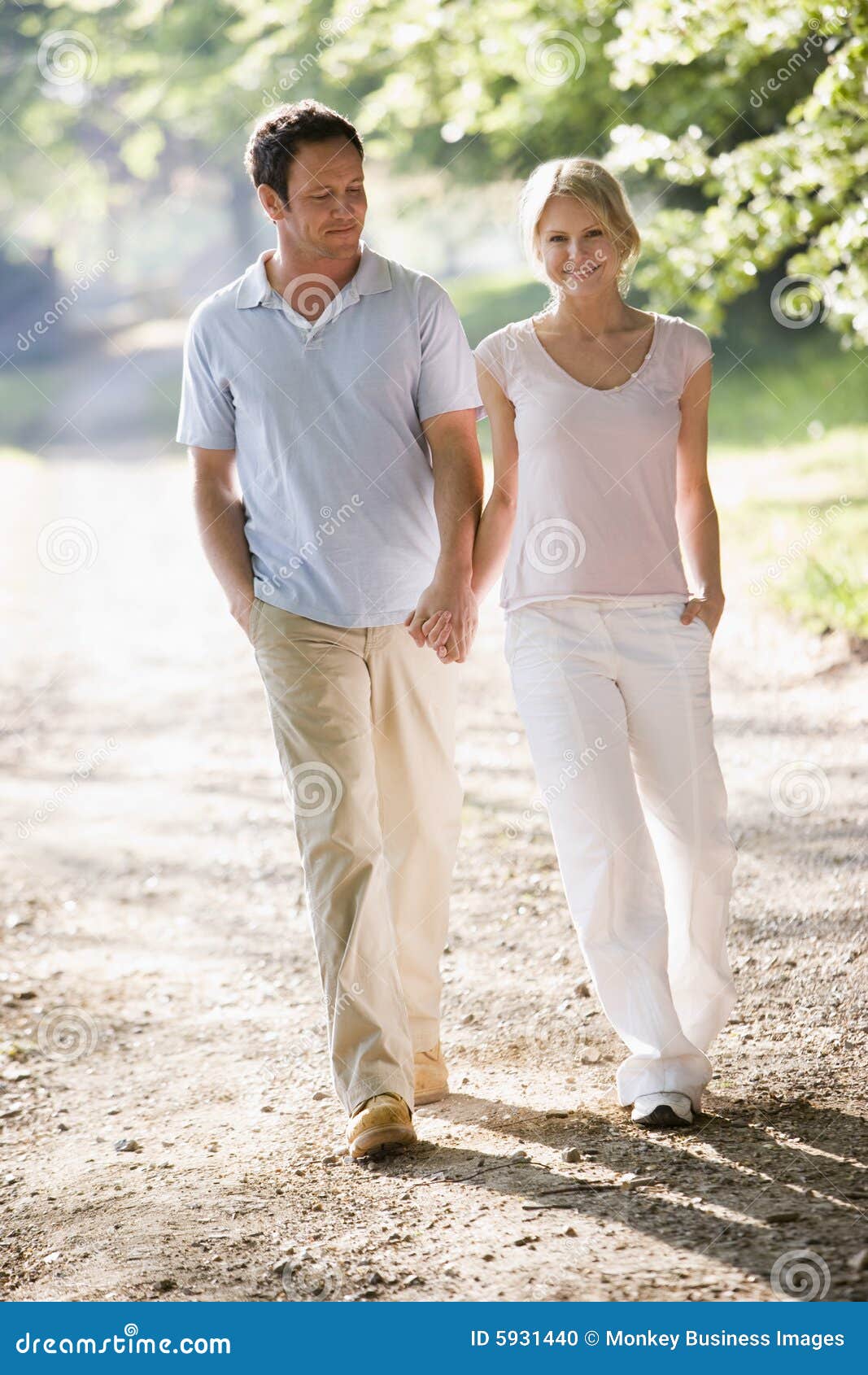Couple Walking Outdoors Holding Hands and Smiling Stock Photo - Image ...