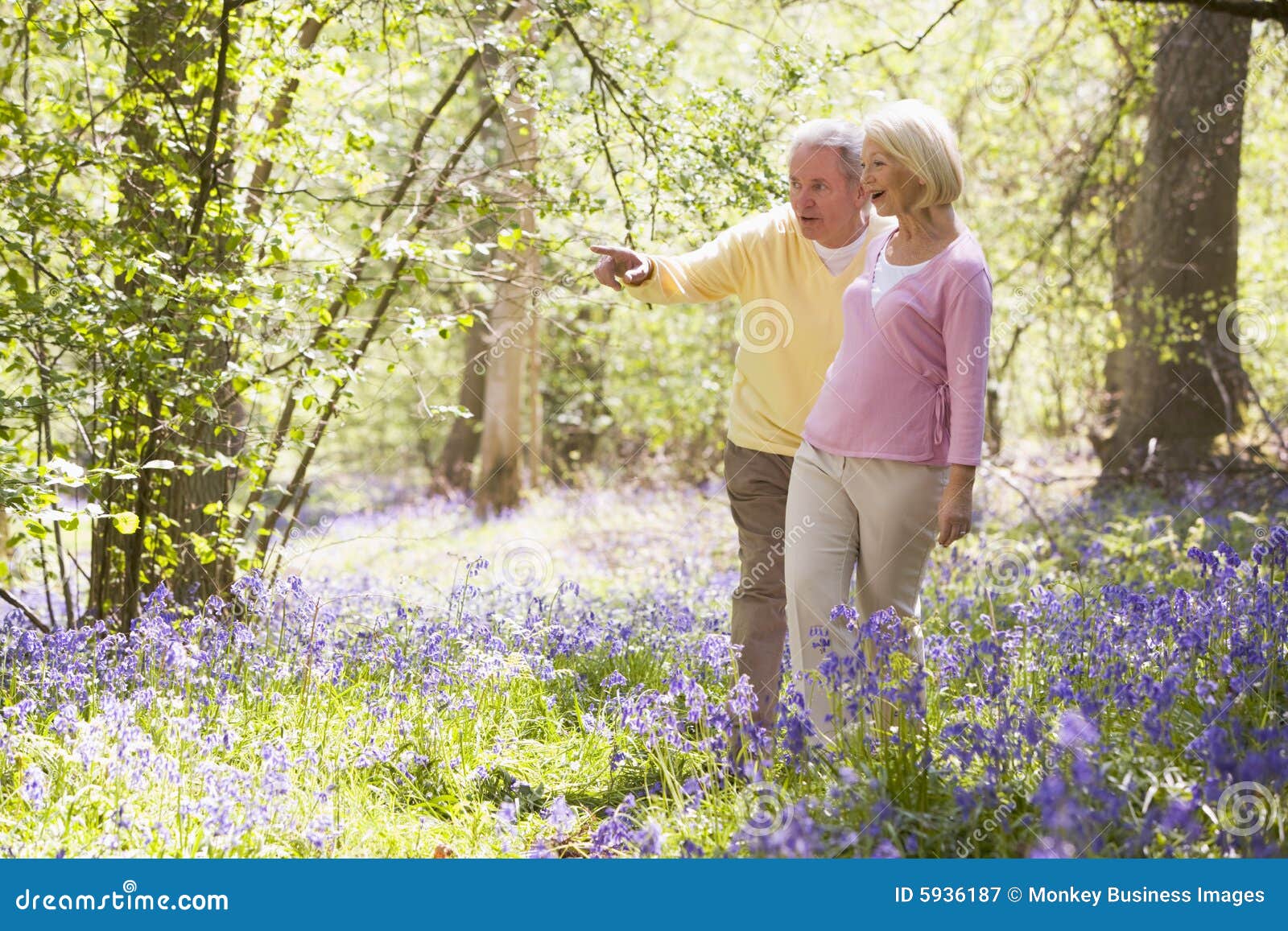 Couple Walking Outdoors Pointing and Smiling Stock Image - Image of ...