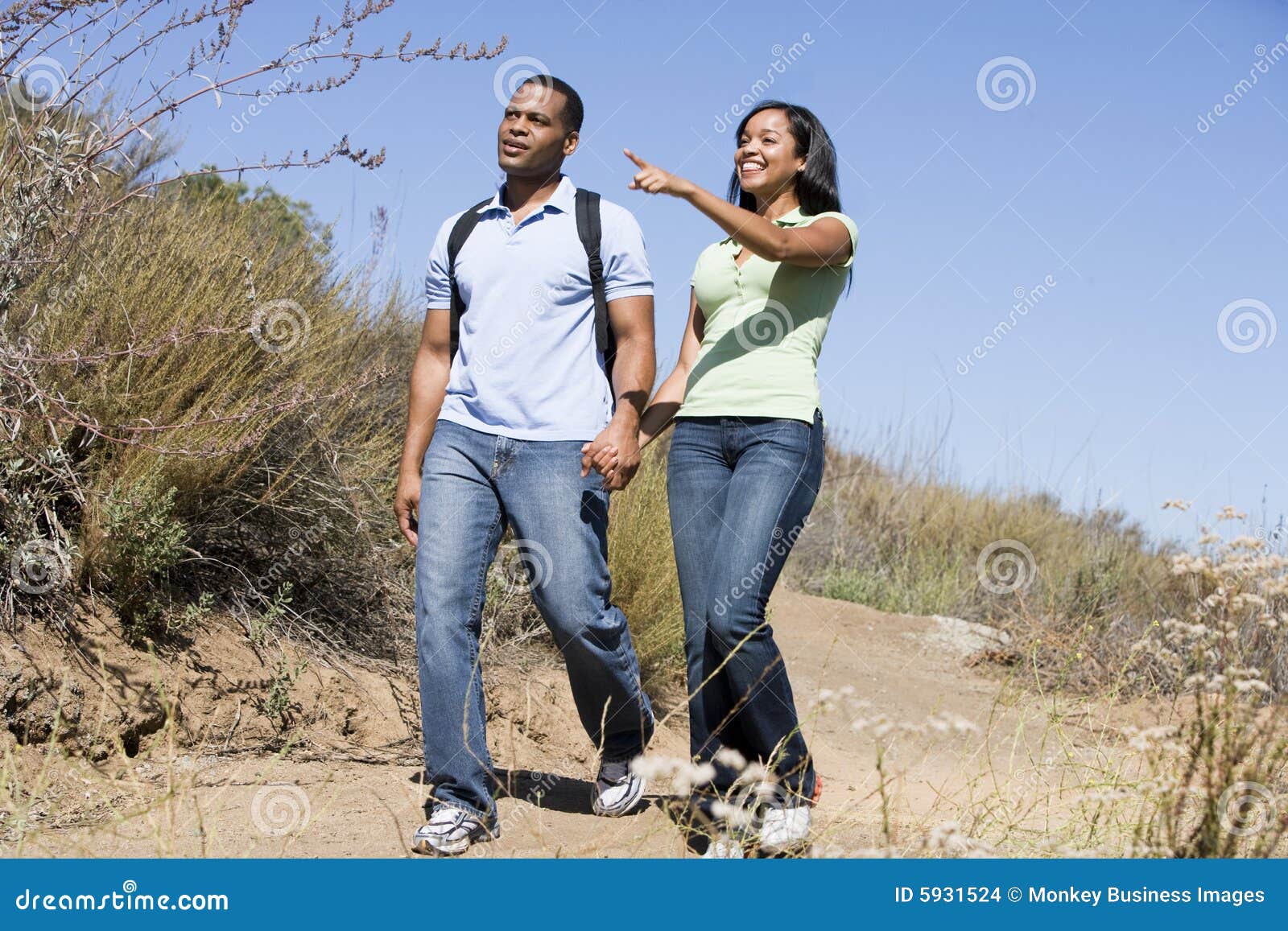Two People Walking Together Holding Hands