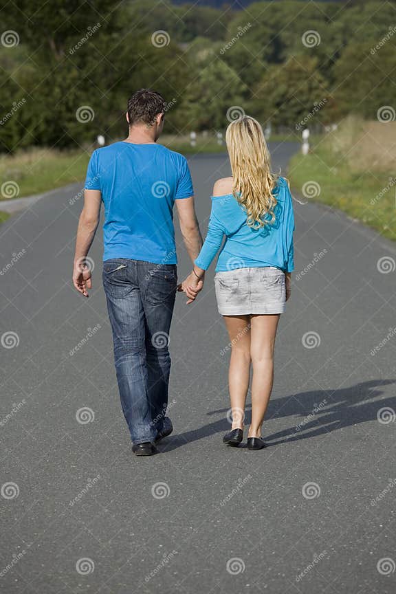 Couple walking on the road stock image. Image of together - 20750567