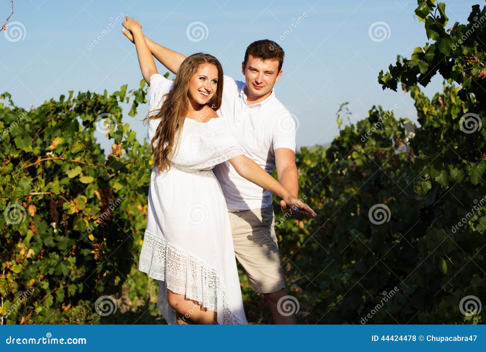 Couple Walking in between Rows of Vines Stock Photo - Image of fruit ...