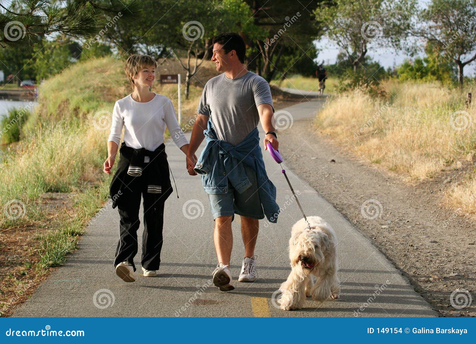 Couple walking their dog stock photo. Image of friends - 149154