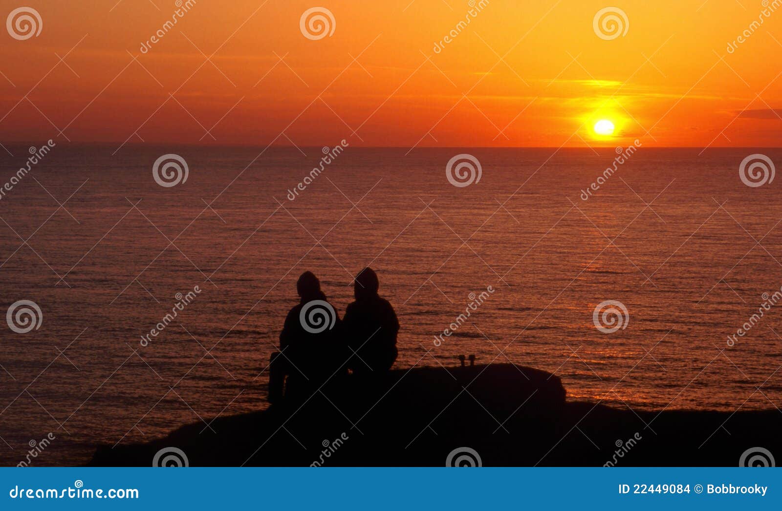 Couple watching the sunset stock photo. Image of companion - 22449084