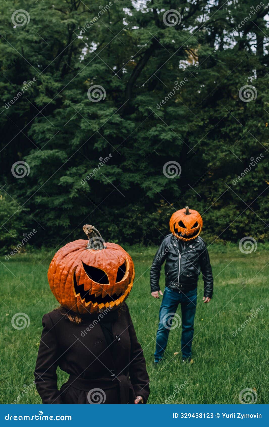 A Couple Wearing Halloween Pumpkins Standing One Behind Another in a ...