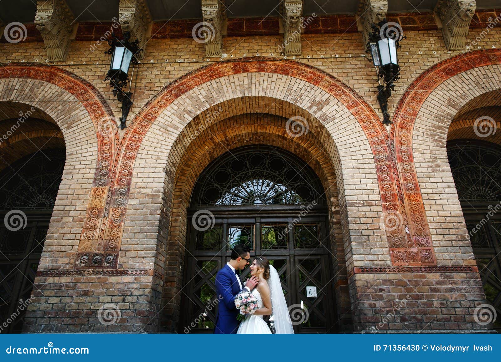 Couple in the Wedding Day Under Arch Stock Photo - Image of gorgeous ...