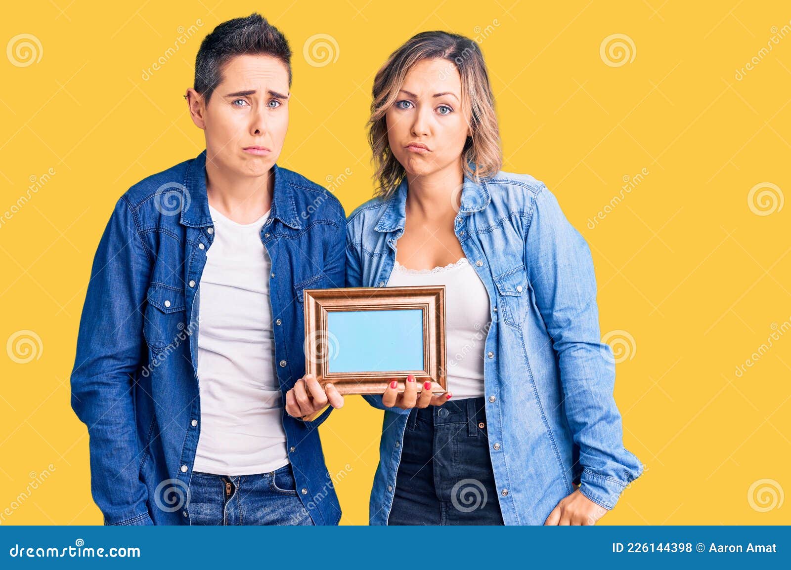 Couple of Women Holding Empty Frame Depressed and Worry for Distress ...