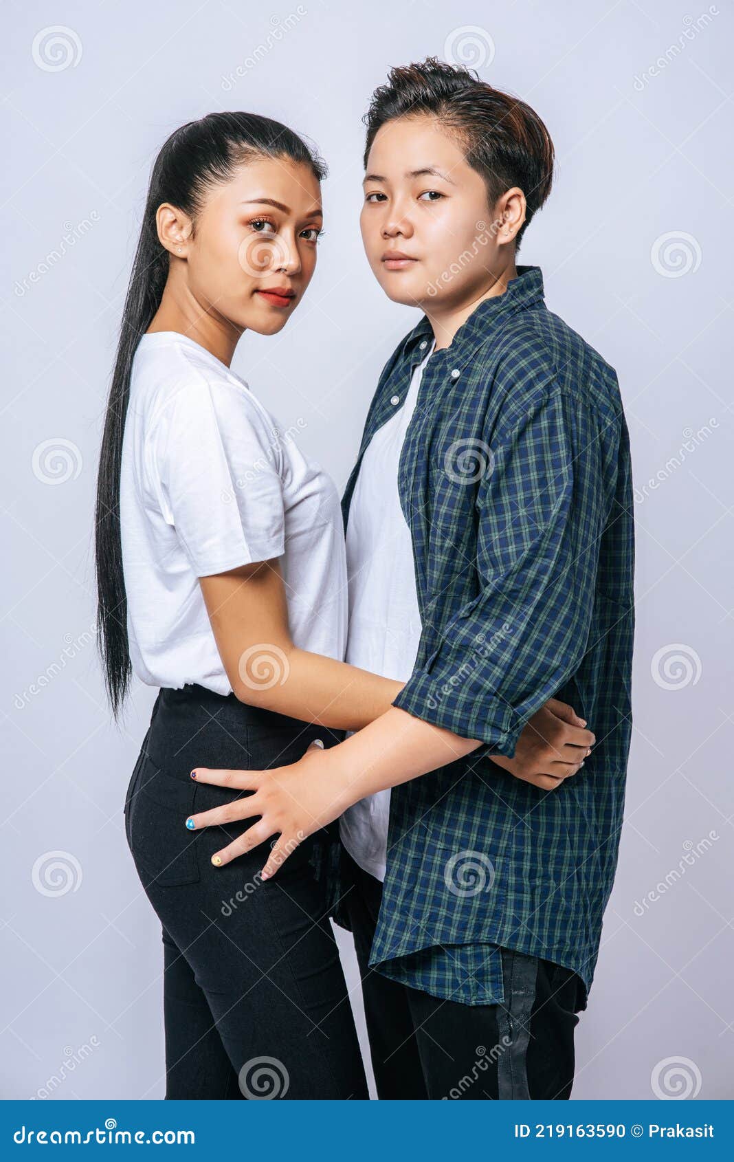 A Couple of Women Standing and Looking Forward Stock Photo - Image of ...