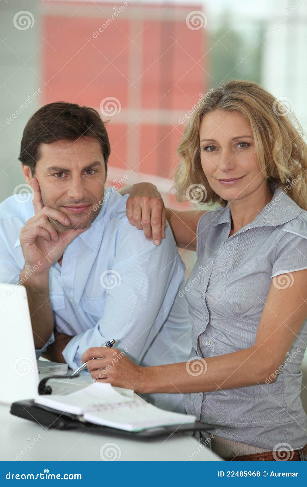 Couple at work smiling stock photo. Image of colleagues - 22485968