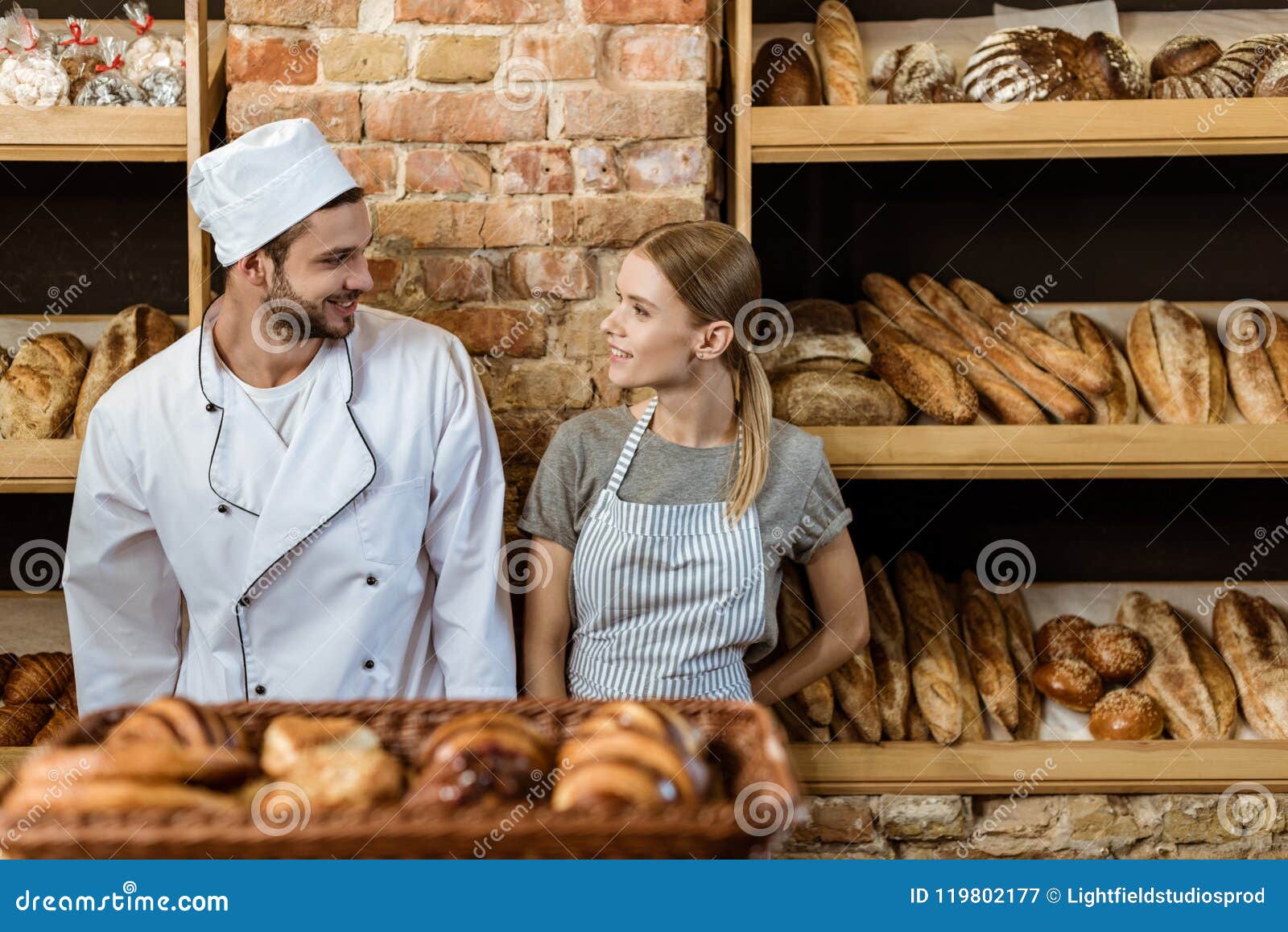 Couple of Young Bakers Standing Stock Image - Image of shop, production ...