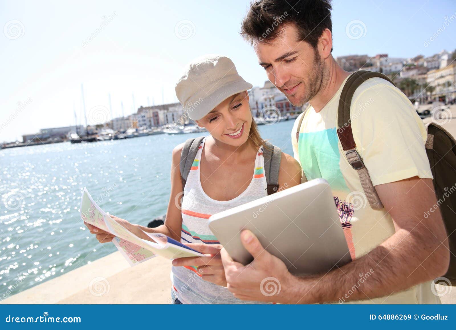 Couple of Young Tourists Using Map and Tablet Stock Image - Image of ...