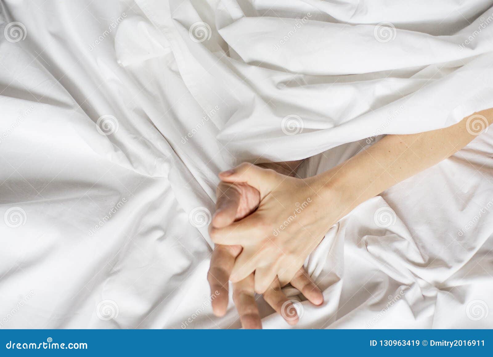 Couples Hold Hands Together In Bed Close Up Touching Each Other On A White Sheets Couple Having