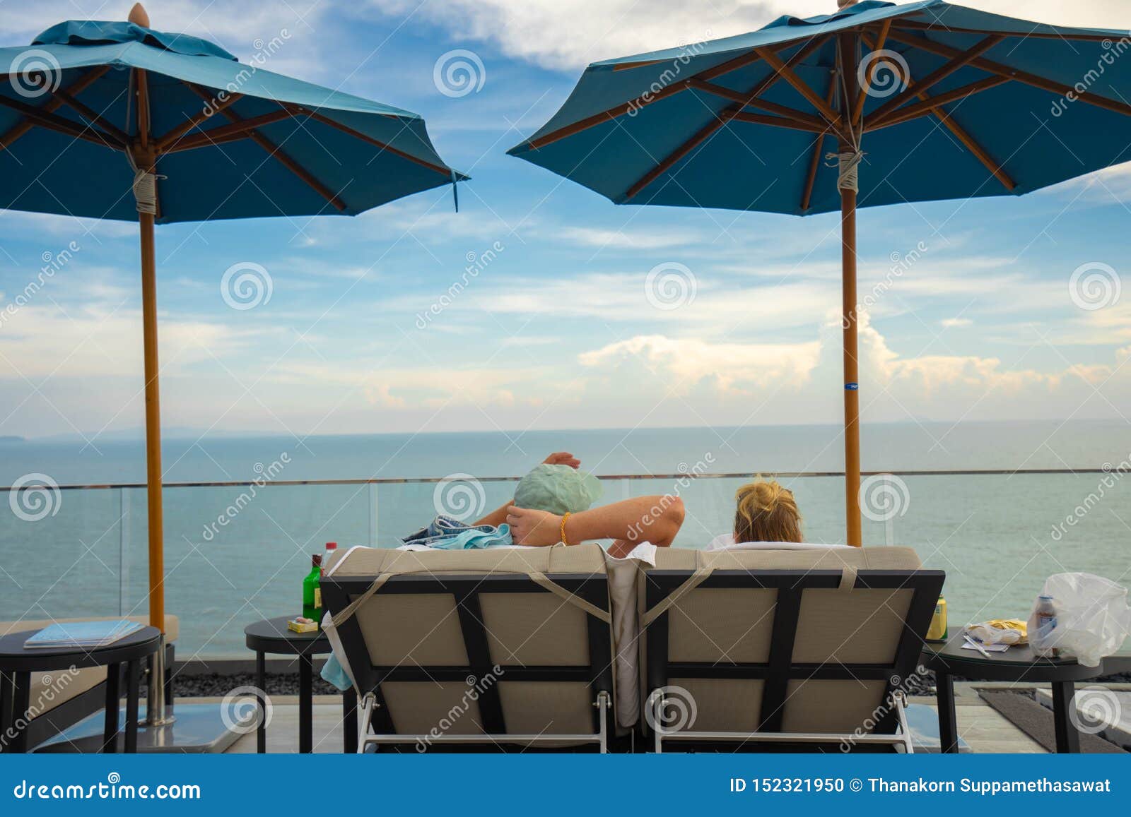 Couples Sitting Together by the Swimming Pool. Vacation and Relaxation ...