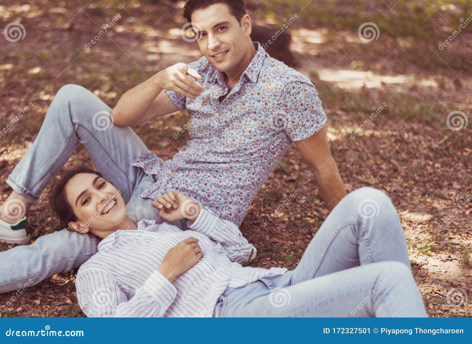 Couple Young Lover Lying Down On Green Grass In Park Together Romantic