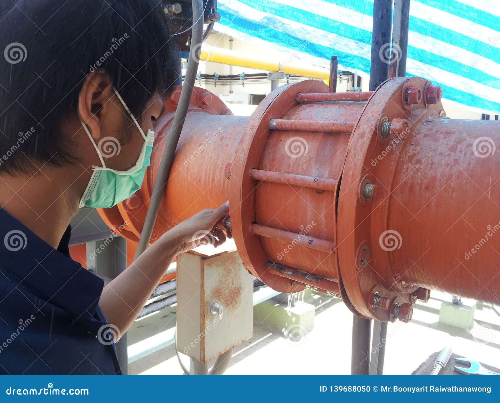 Coupling Flange. the Worker Tightens the Bolts on the Rubber Expansion ...