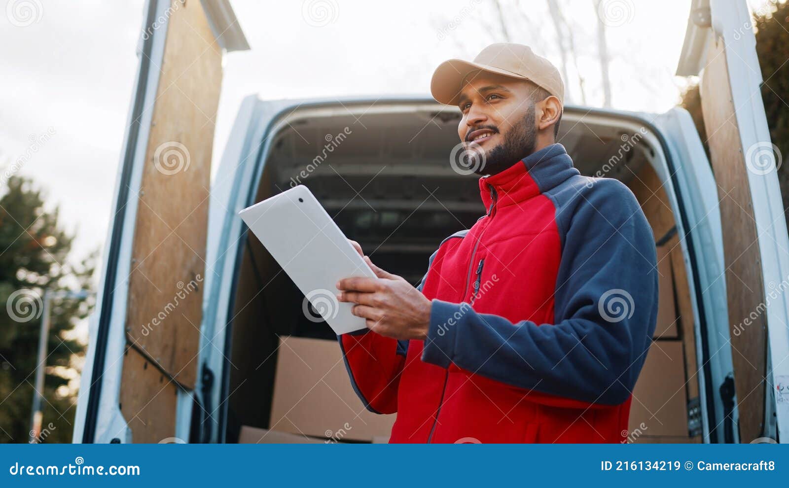 Courier with Digital Tablet Delivering Package. Mailman in Front the ...