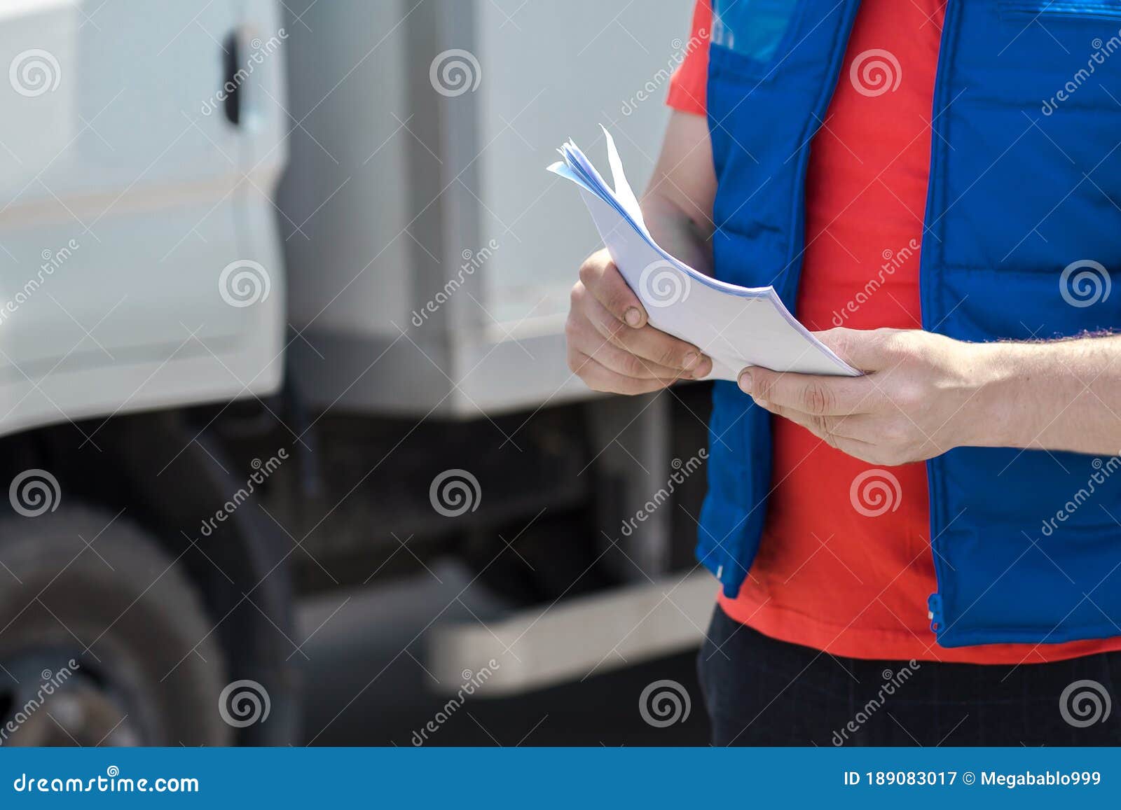 Courier Driver in Uniform Making Notes in Document and Delivery White ...