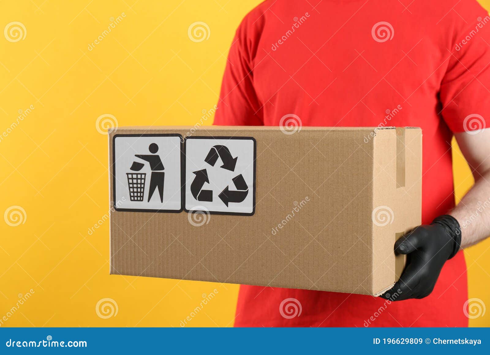 Courier Holding Cardboard Box with Different Packaging Symbols on ...