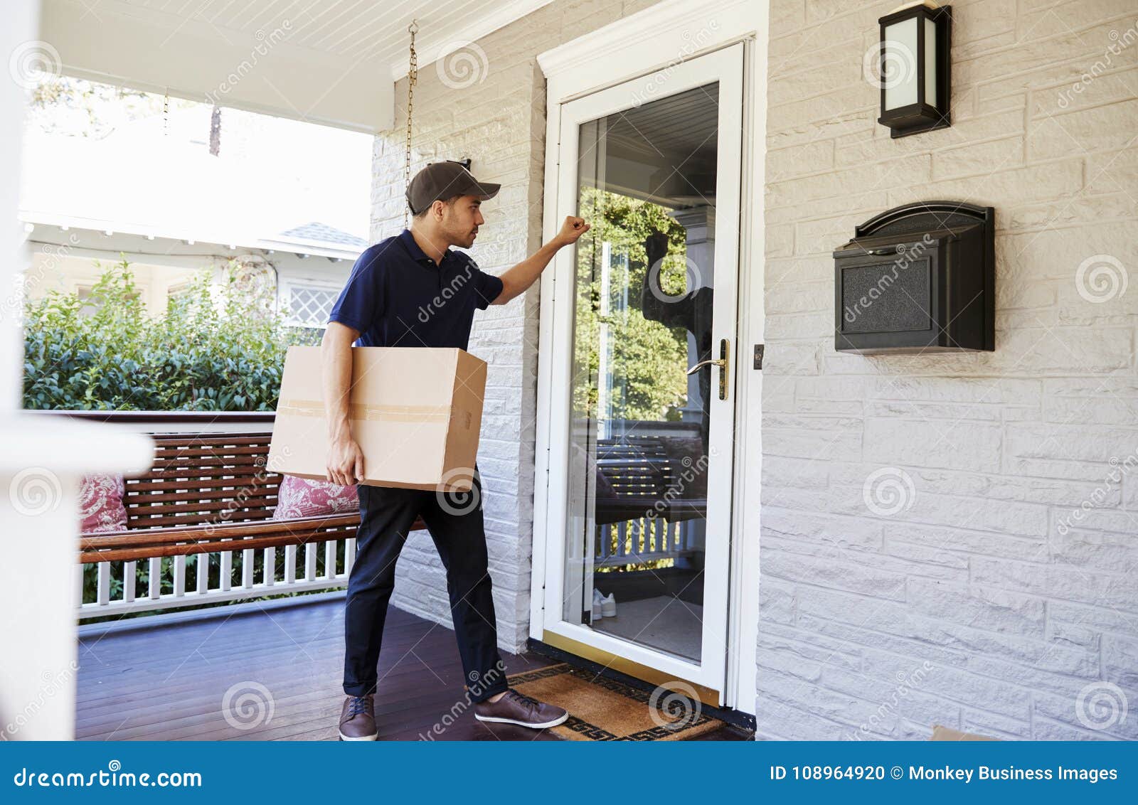 Courier Knocking on Door of House To Deliver Package Stock Photo ...
