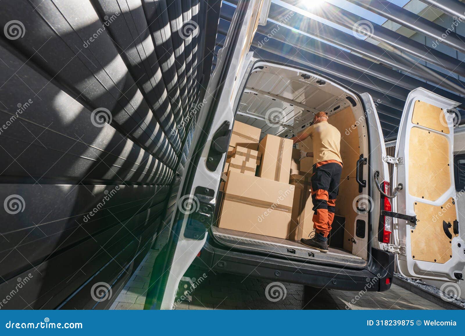 Courier Loading Cargo Boxes into Van for Delivery Stock Image - Image ...