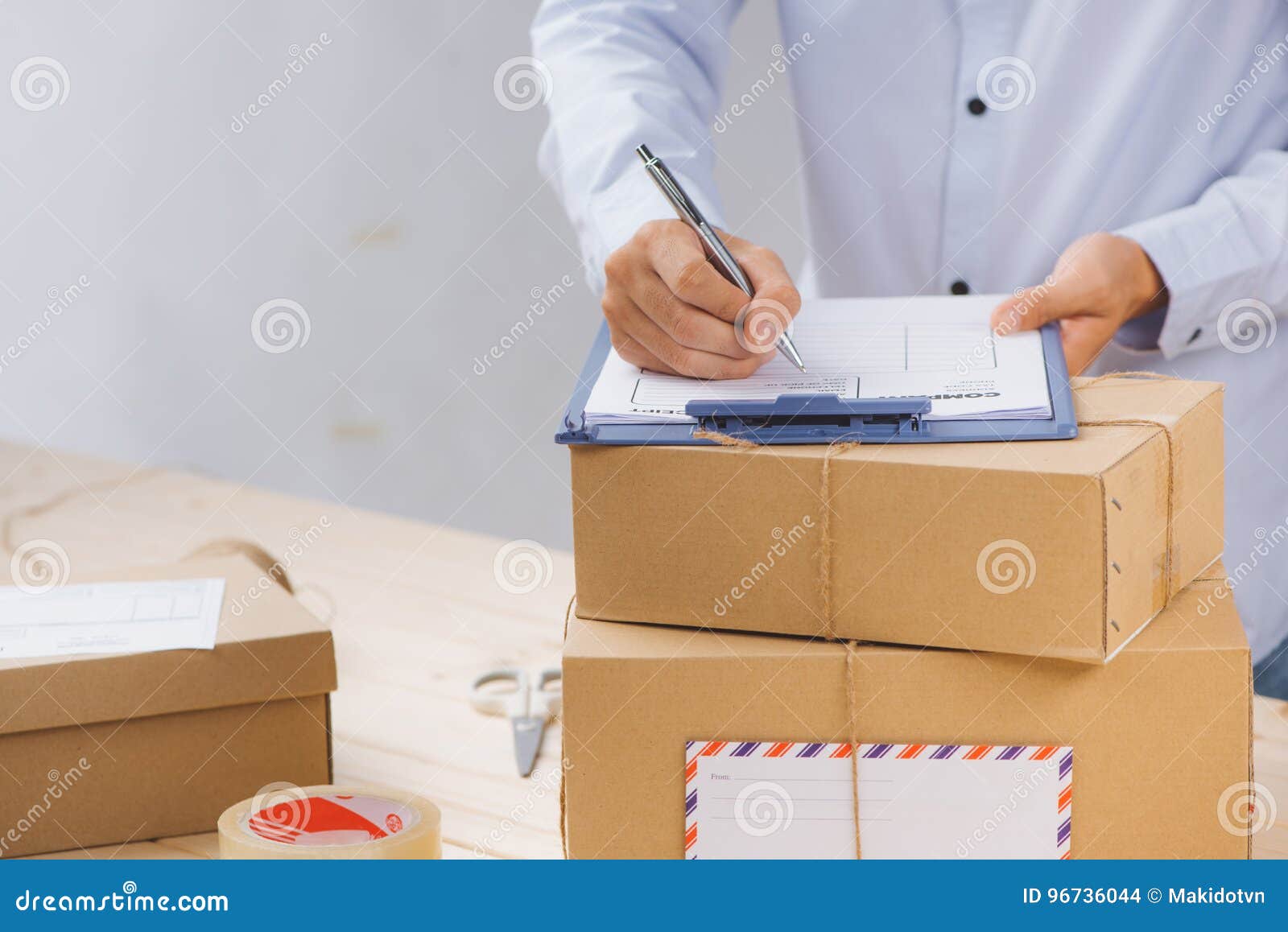Courier Making Notes In Delivery Receipt Among Parcels On Boxes Stock ...