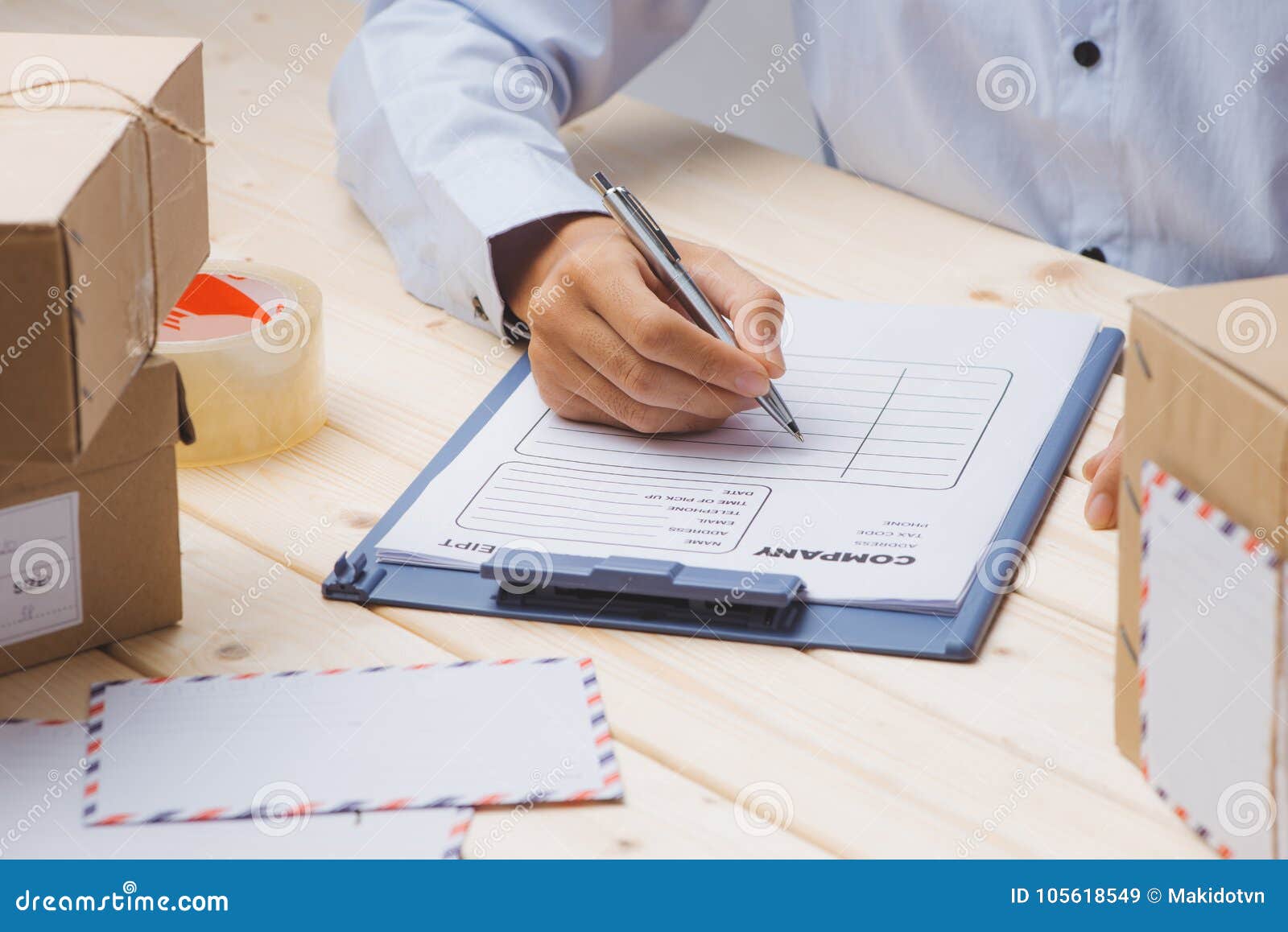 Courier Making Notes in Delivery Receipt among Parcels at Table Stock ...