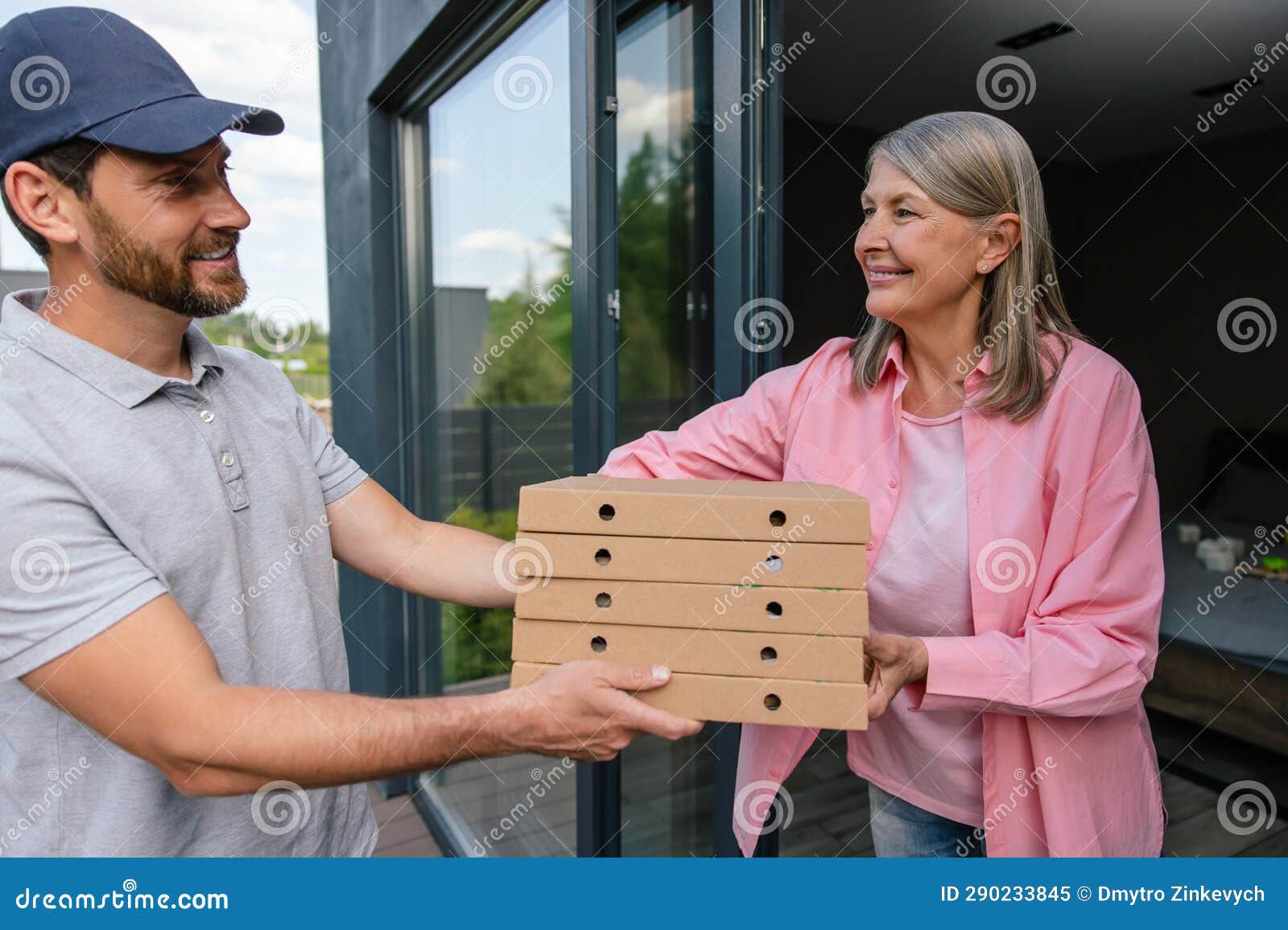 Courier Man Handling Pizza To Female Client. Stock Image - Image of ...