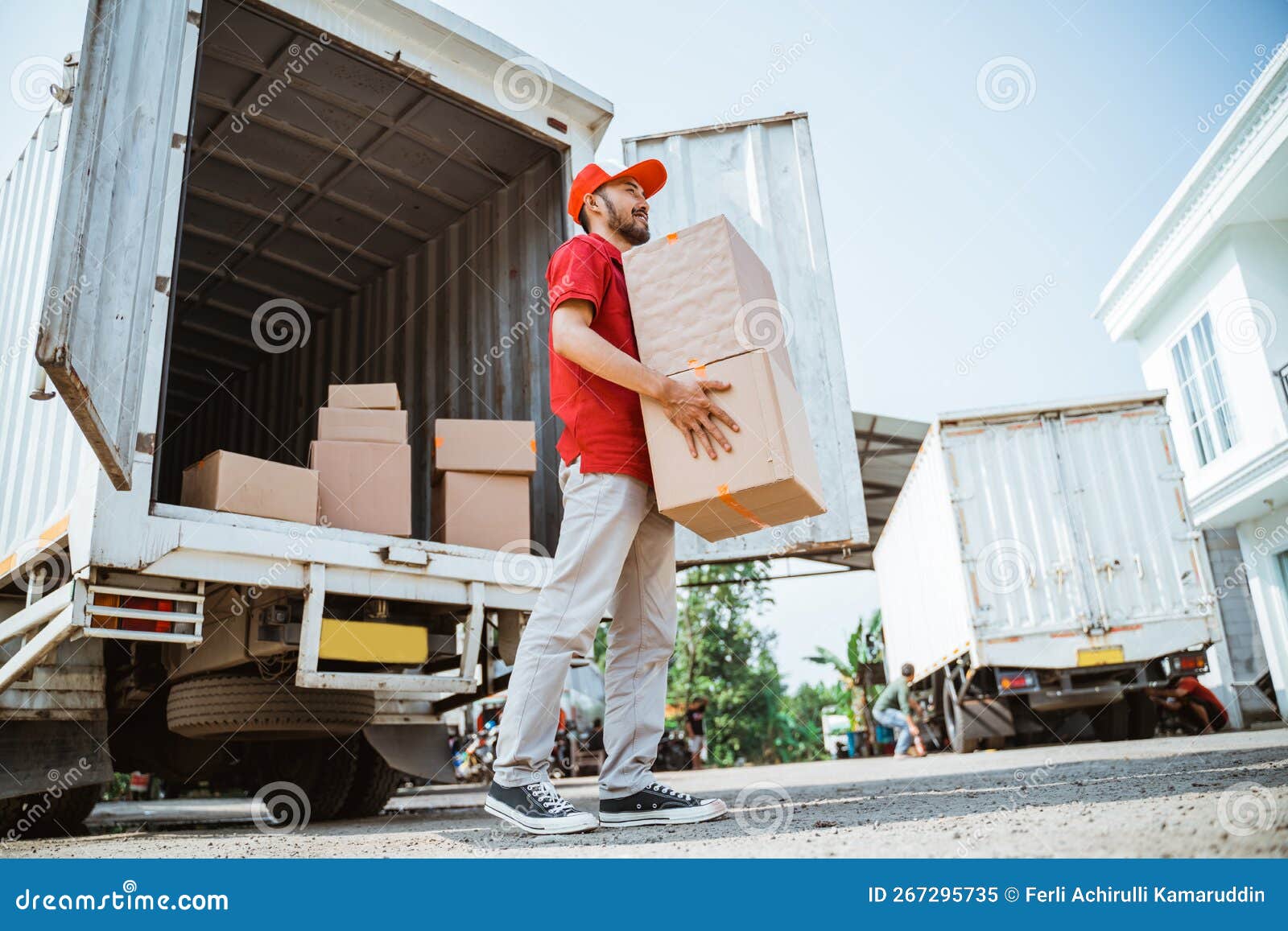 Courier Man in Red Uniform Lifting Parcel Box from Container Stock ...