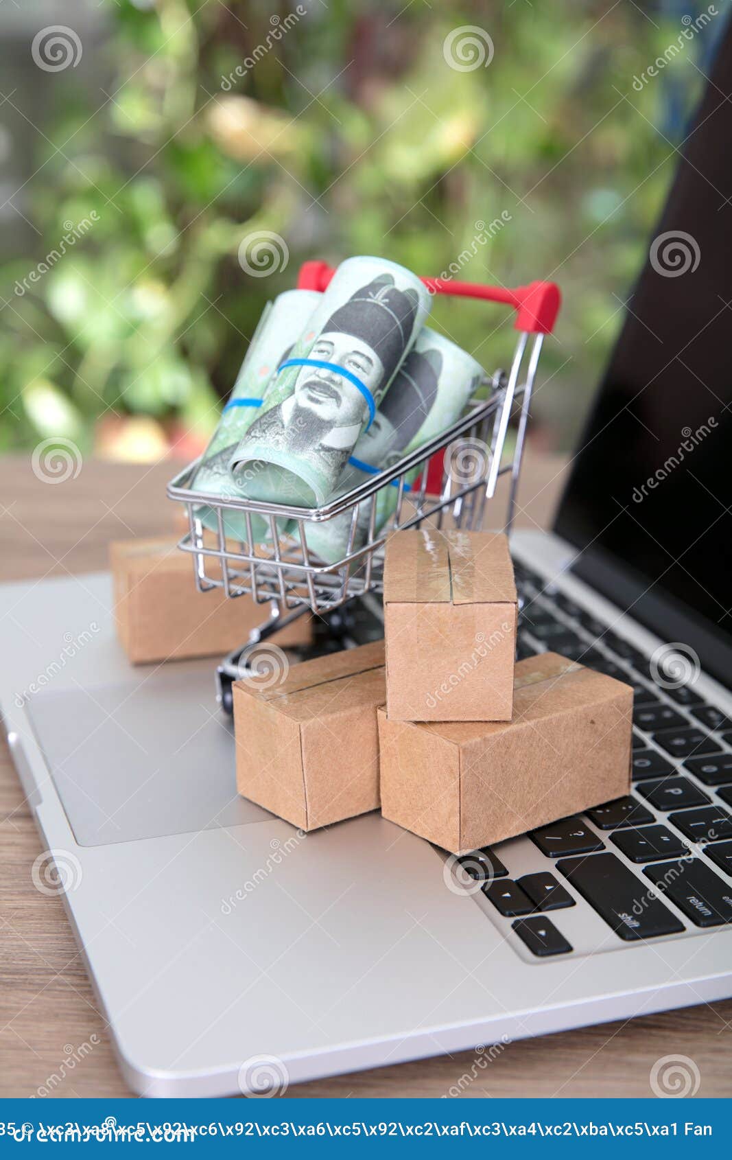 Courier Package on the Computer Keyboard and a Shopping Cart with ...