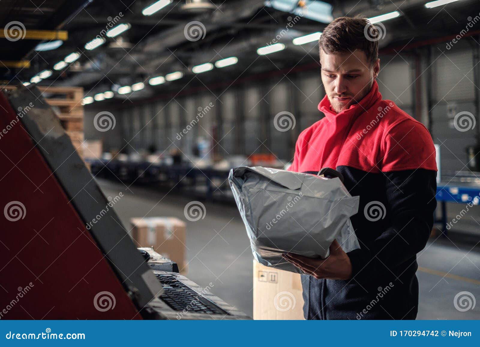 Courier Picks Up Package on a Warehouse Stock Photo - Image of loading ...