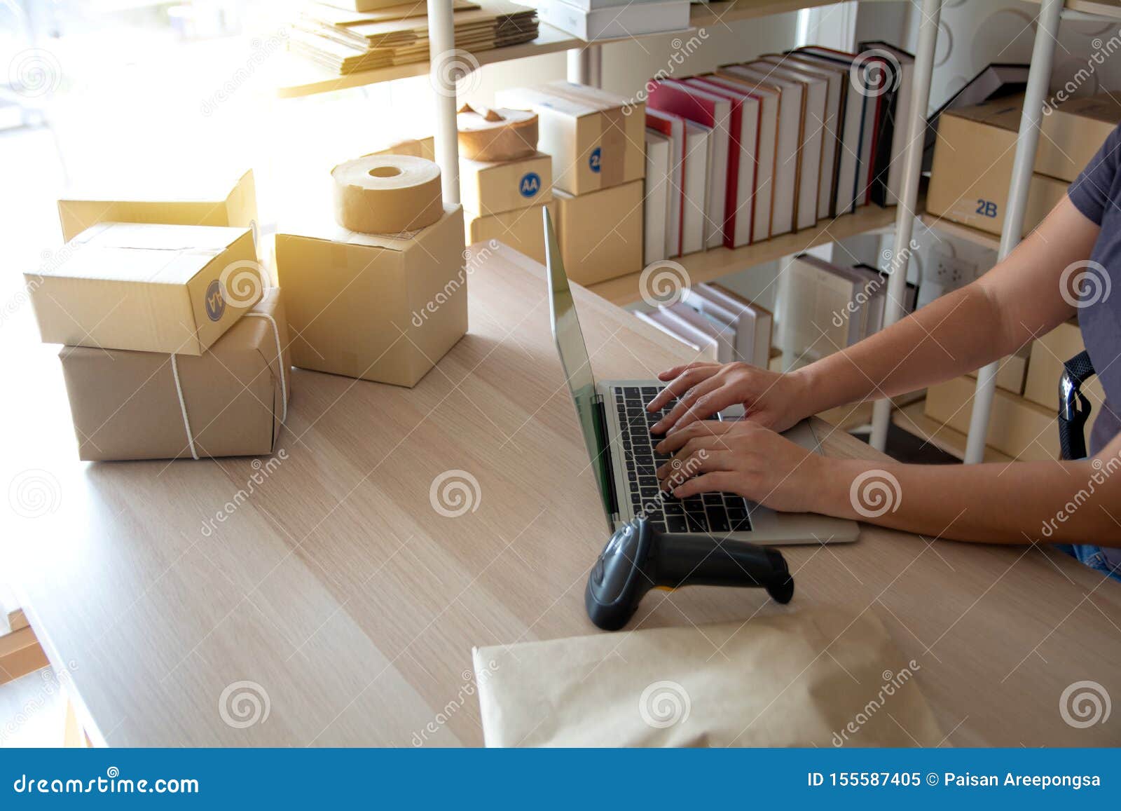 Courier Scanning Cardboard Box with Barcode Scanner in Warehouse. Close ...