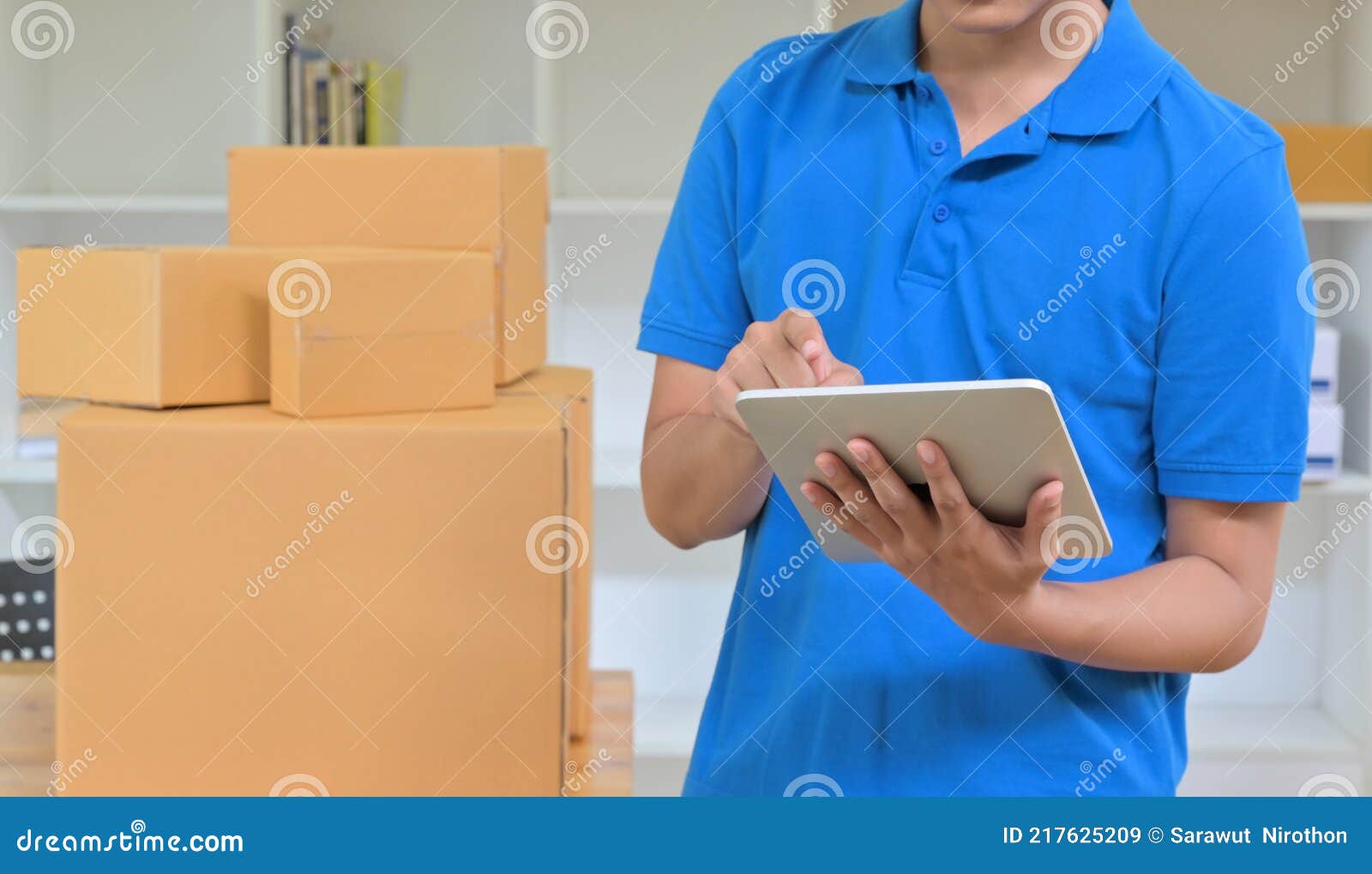 The Courier is Using a Tablet To Record the Delivery Information Stock ...