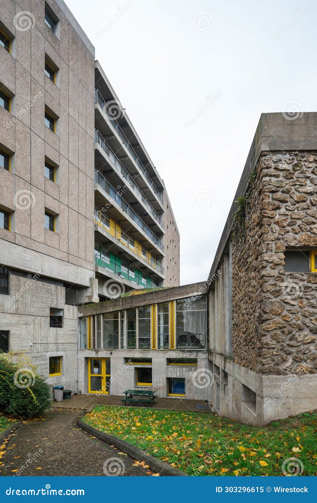 A Courtyard of a High Rise Building with Small Grass in Front of it ...
