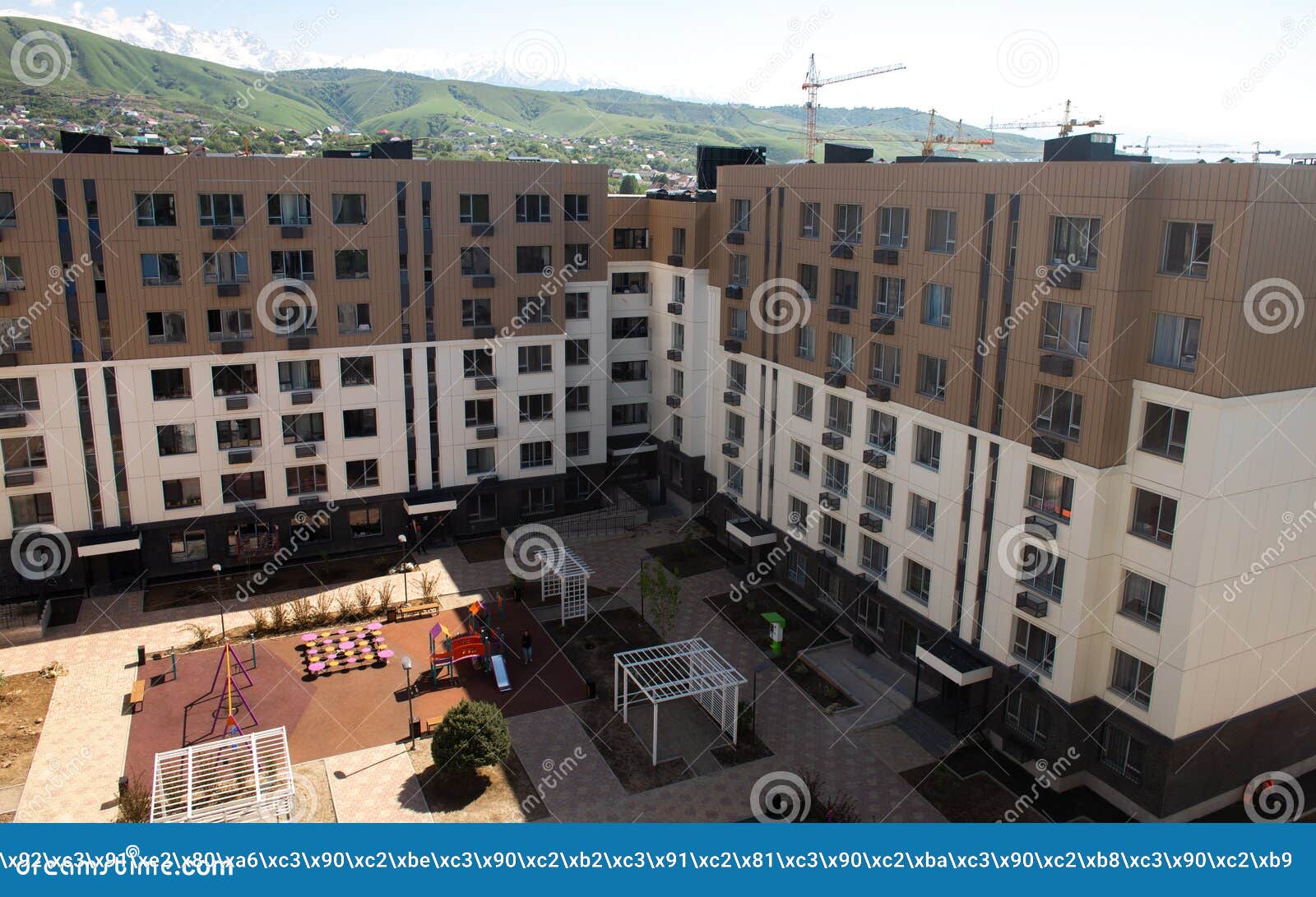 The Courtyard of a New Multi-storey House with a Playground View from ...