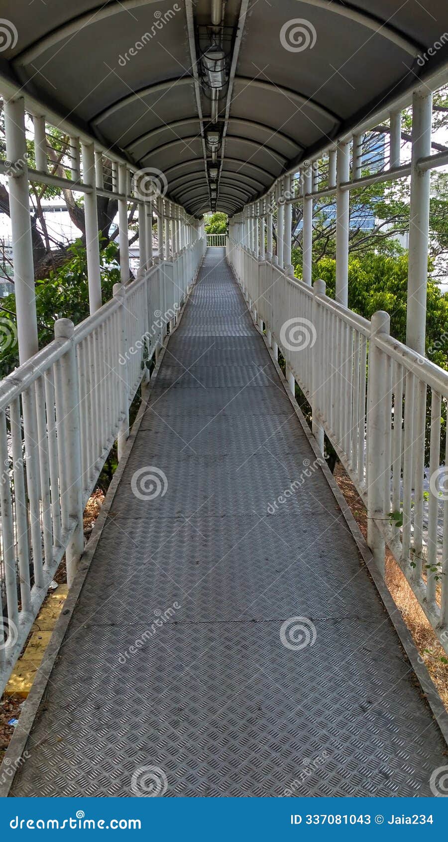 A Covered Pedestrian Bridge with a Metallic Textured Pathway Stock ...