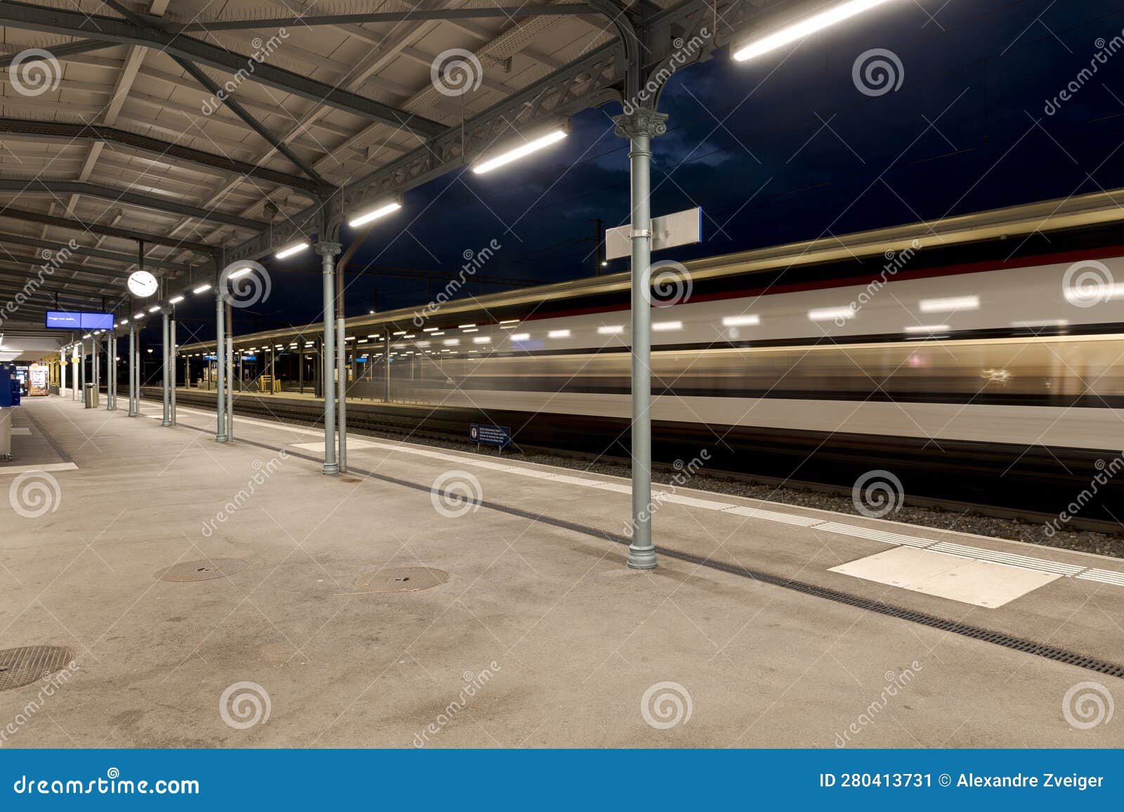 Covered Station Platform Illuminated by Led Lights. the Train Passes by ...