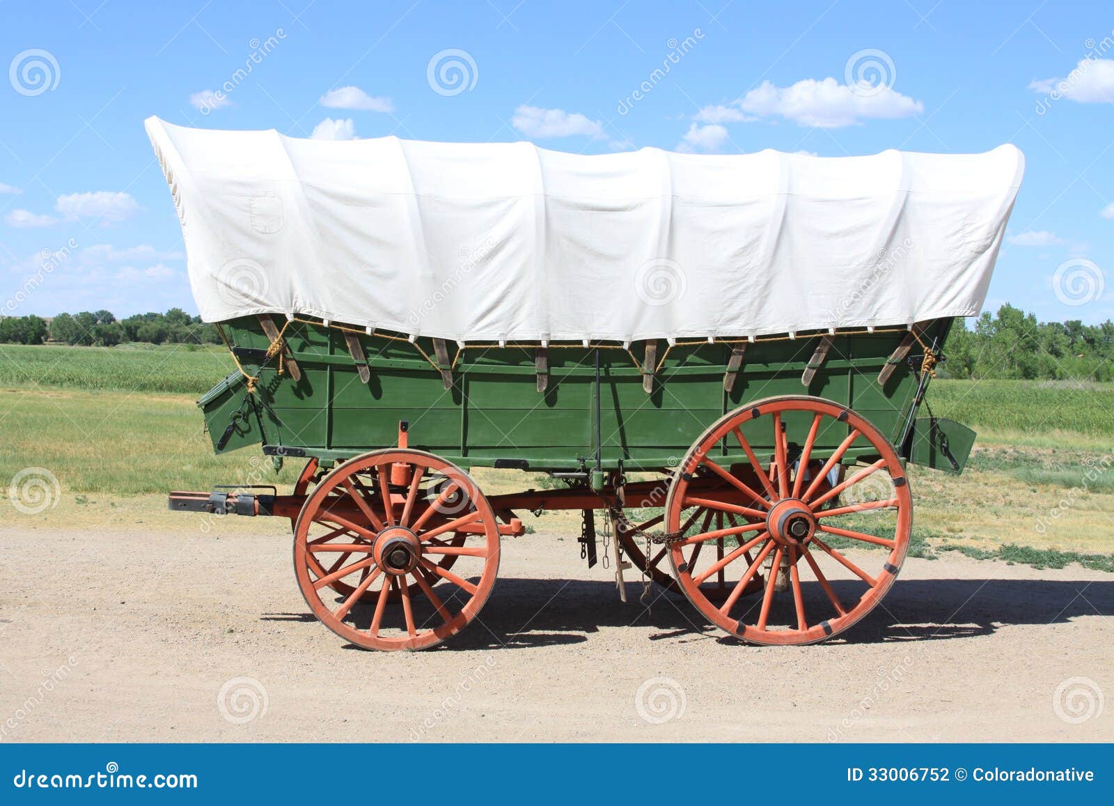 An Old Covered Wagon Wheel. Traditional Wooden Tumbrel, Wooden Crates ...